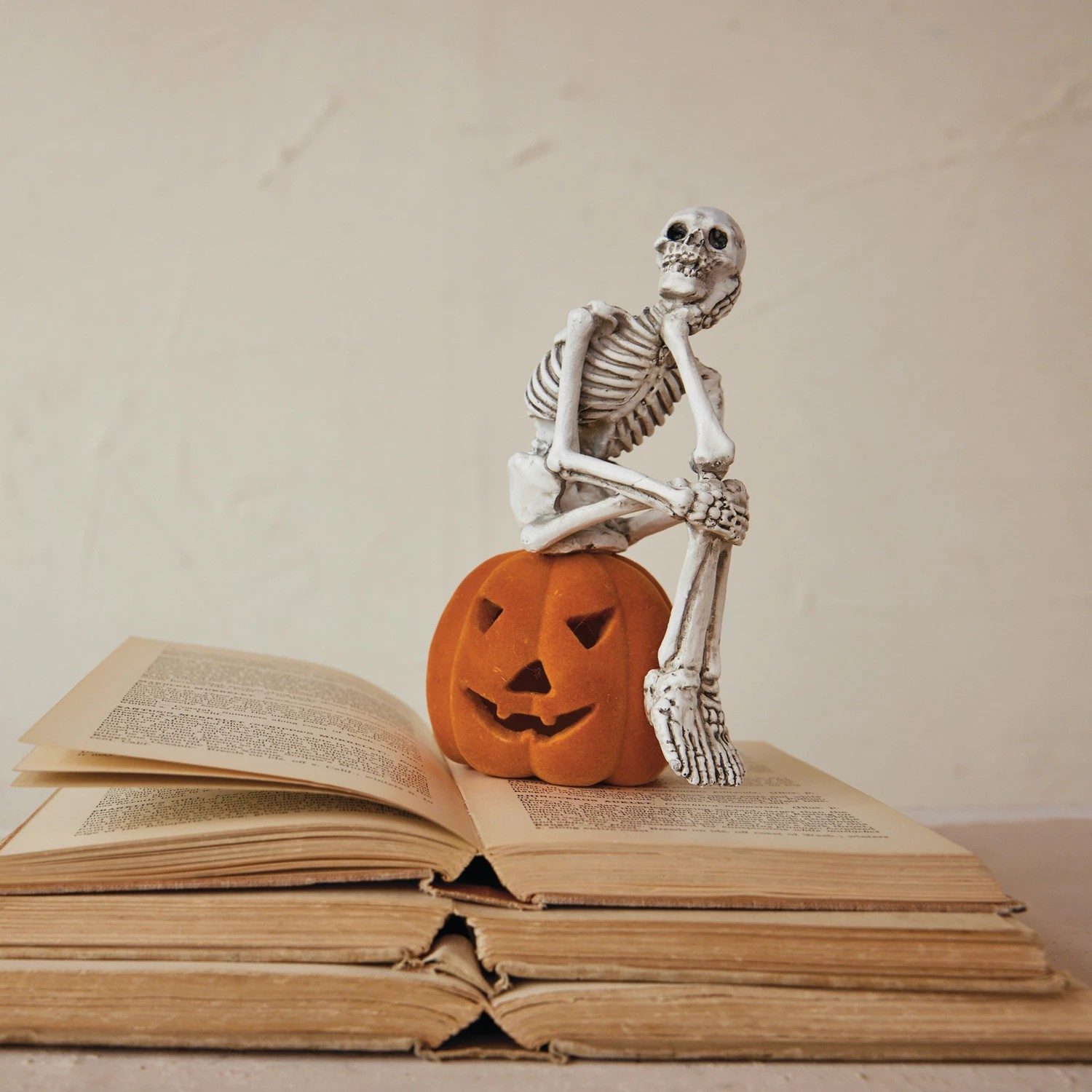 Resin Skeleton Sitting on Flocked Jack-O-Lantern – DDC Shoppe